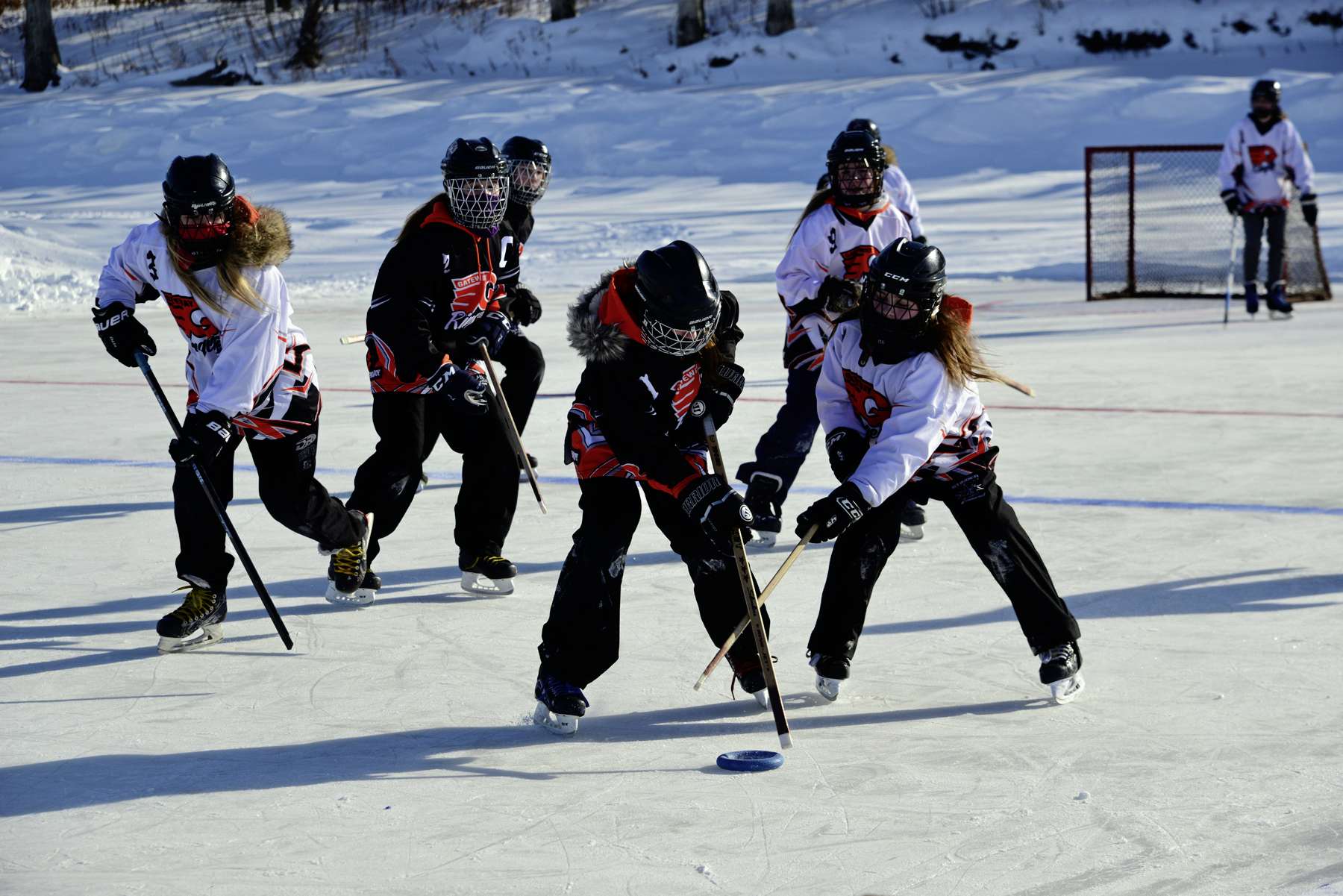 Playing ringette by the river – Our Communities