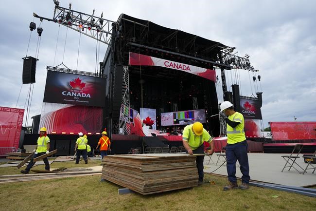 Protesters march for freedom as much larger crowds celebrate Canada Day ...