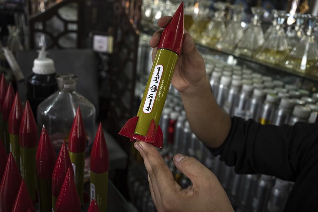 Rocket perfume, anyone? A Gaza vendor sells scents in bottles shaped like rockets fired at ...