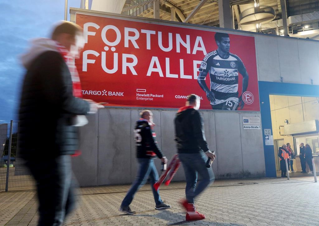 German soccer club gives away tickets for crowd of 52,000 to connect ...