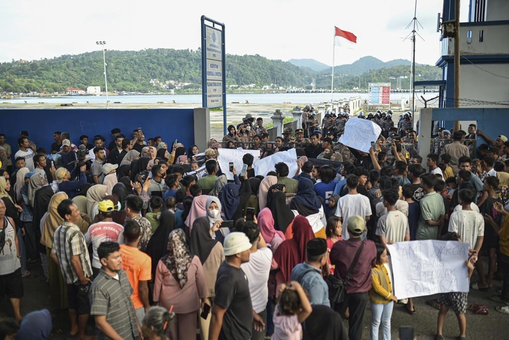 Hundreds of residents on Indonesian island protest the growing arrival ...