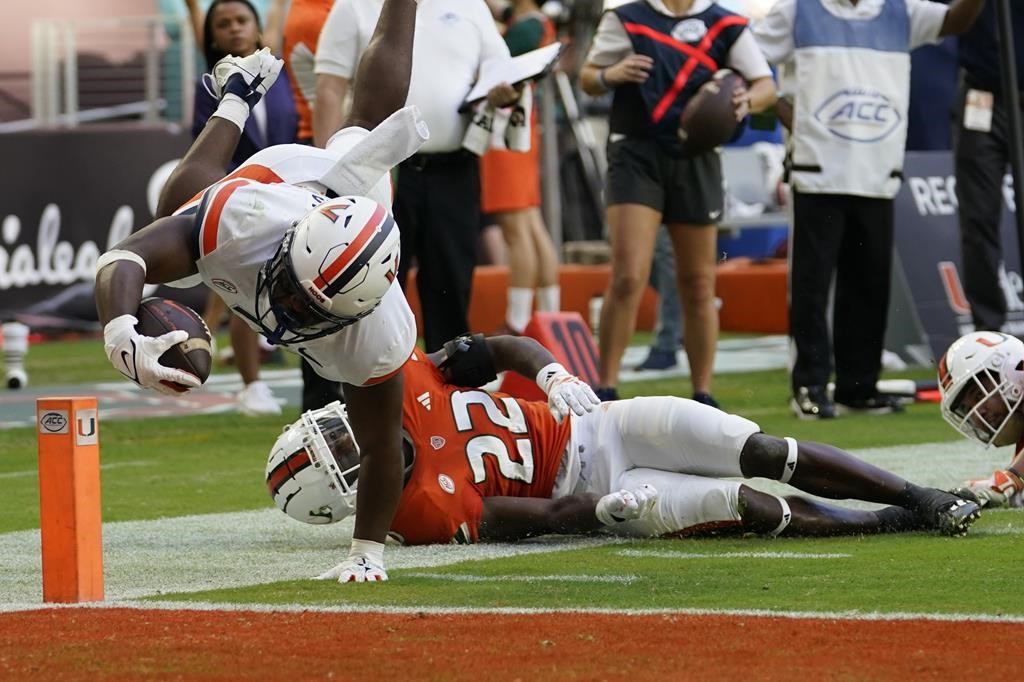 UVA’s Mike Hollins, Michigan’s Blake Corum, Holy Cross’ Jacob Dobbs win ...