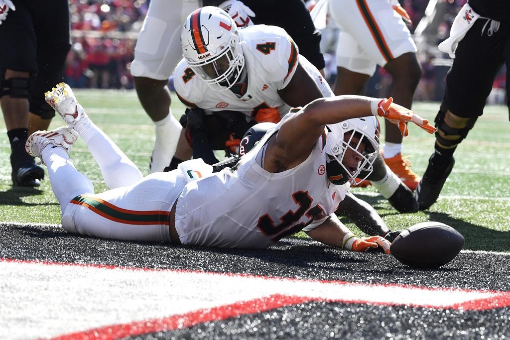 Cam Ward throws for 4 touchdowns, No. 6 Miami survives Louisville ...