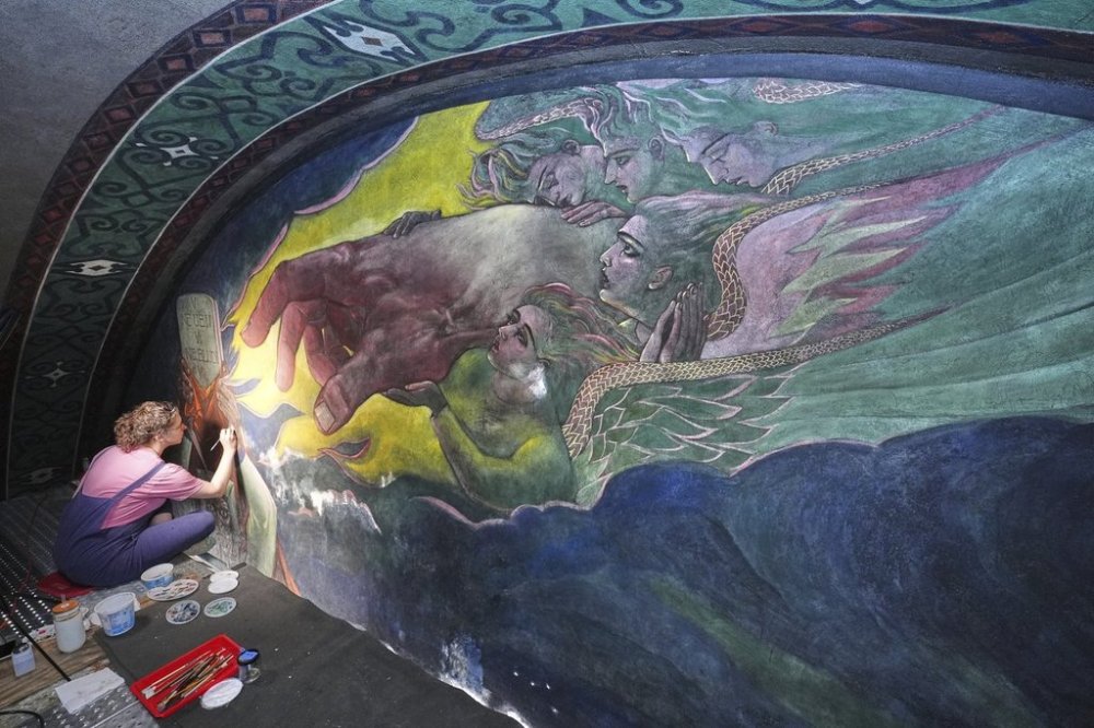Inside a historic church painted with murals that reflect searing ...